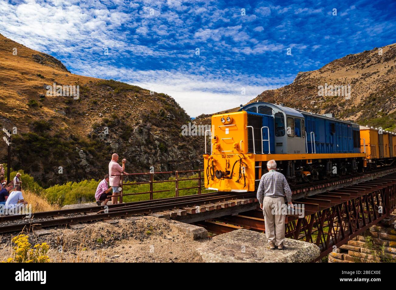 Tourists watch the Pukerangi bound train hauled by DJ 3211 cross the ...