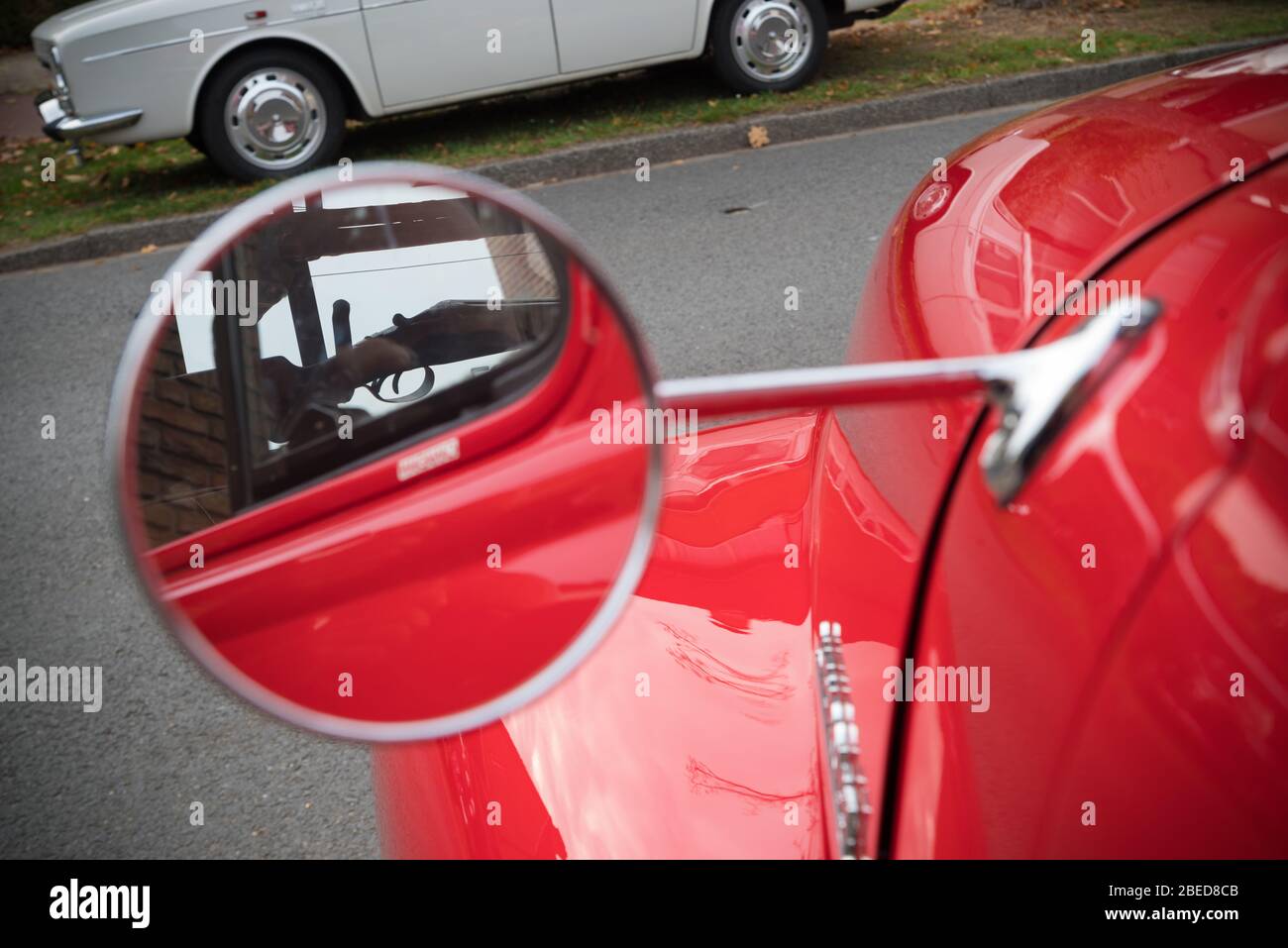 round side mirror of a red retro car Stock Photo - Alamy
