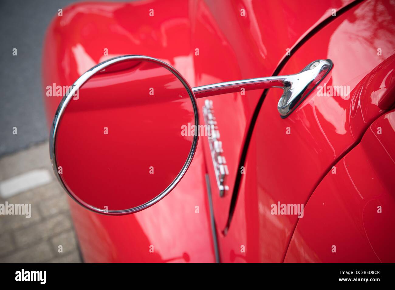 round side mirror of a red retro car Stock Photo - Alamy