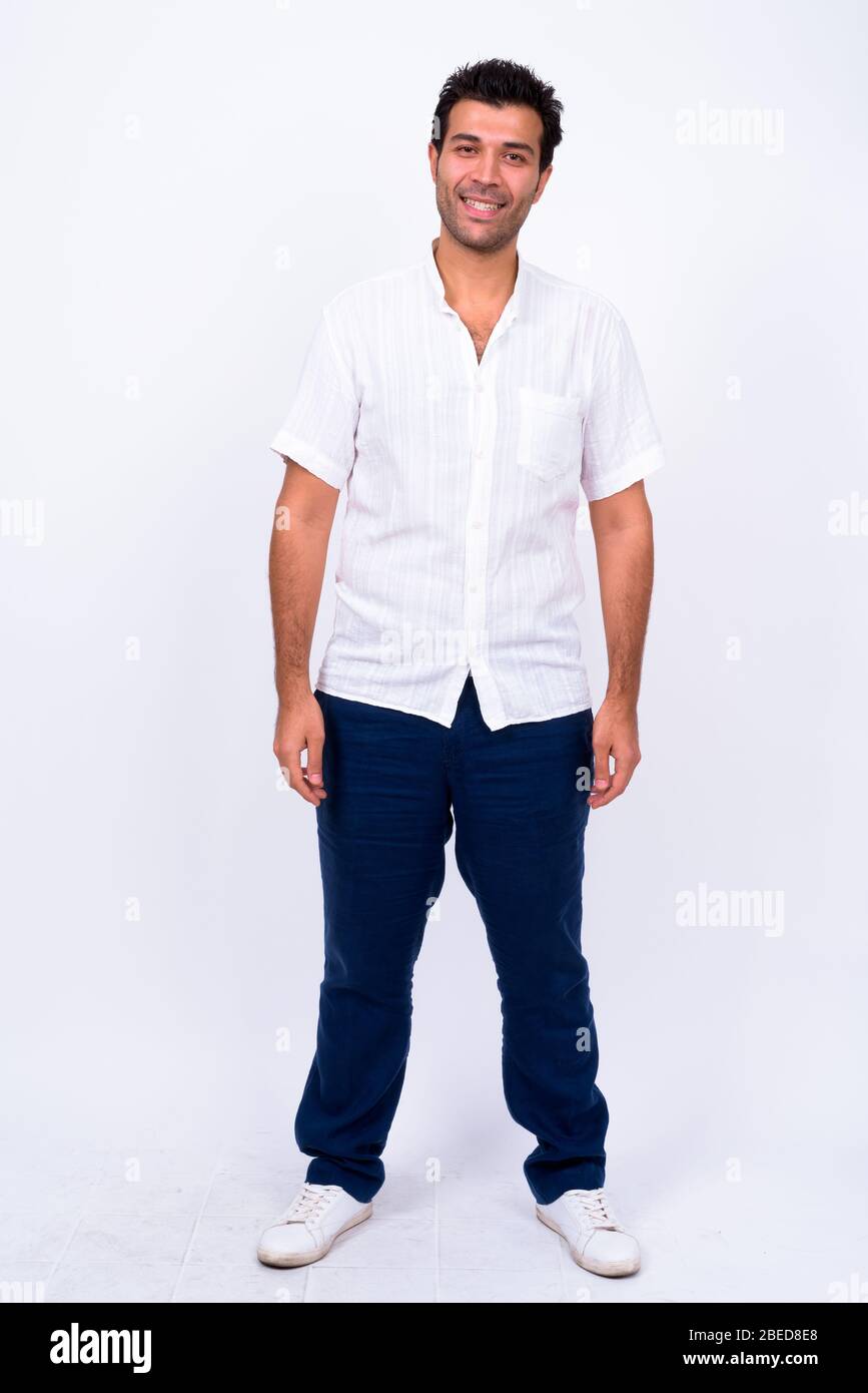 Full body shot of happy handsome Turkish man smiling Stock Photo - Alamy