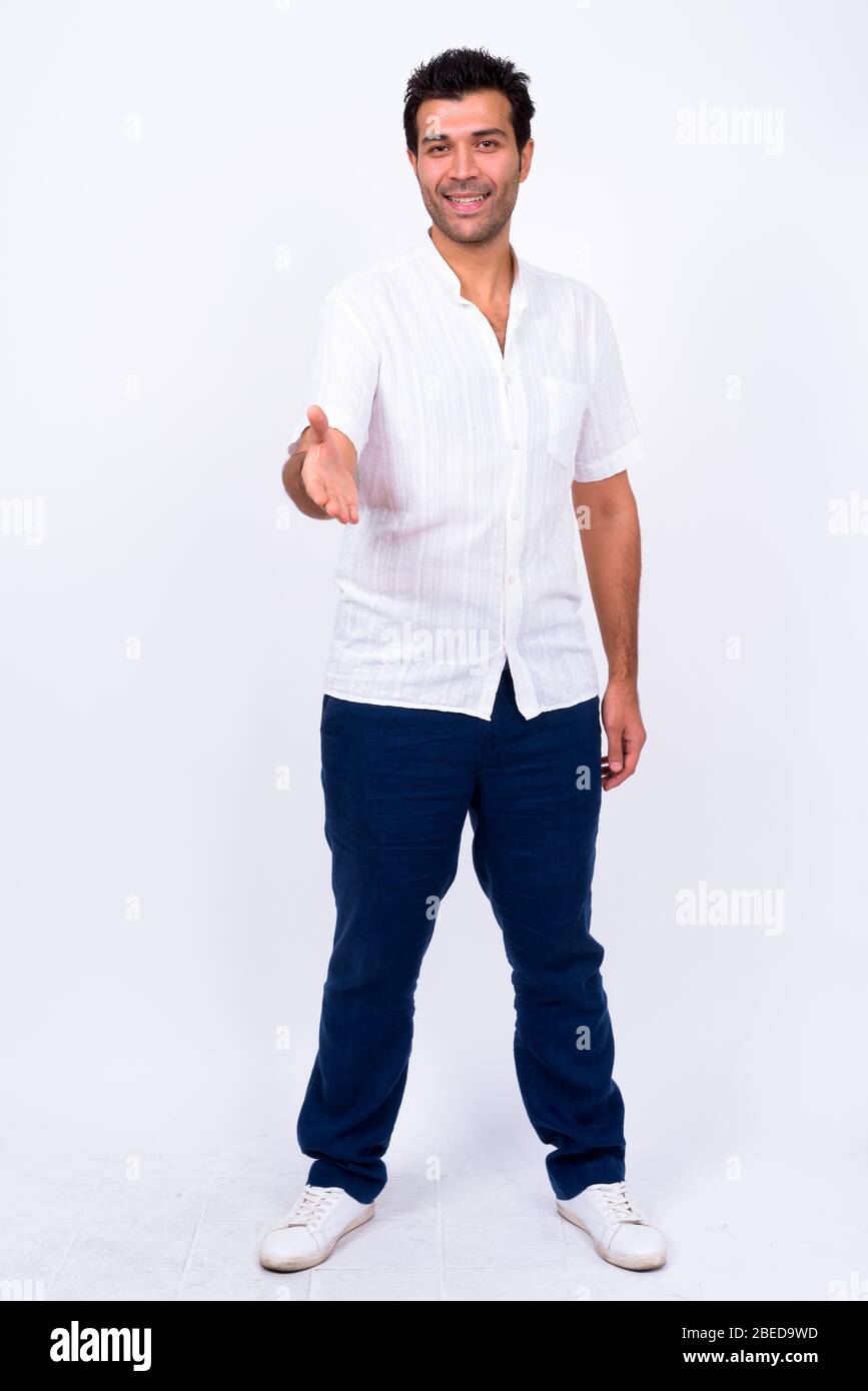 Full body shot of happy handsome Turkish man giving handshake Stock ...
