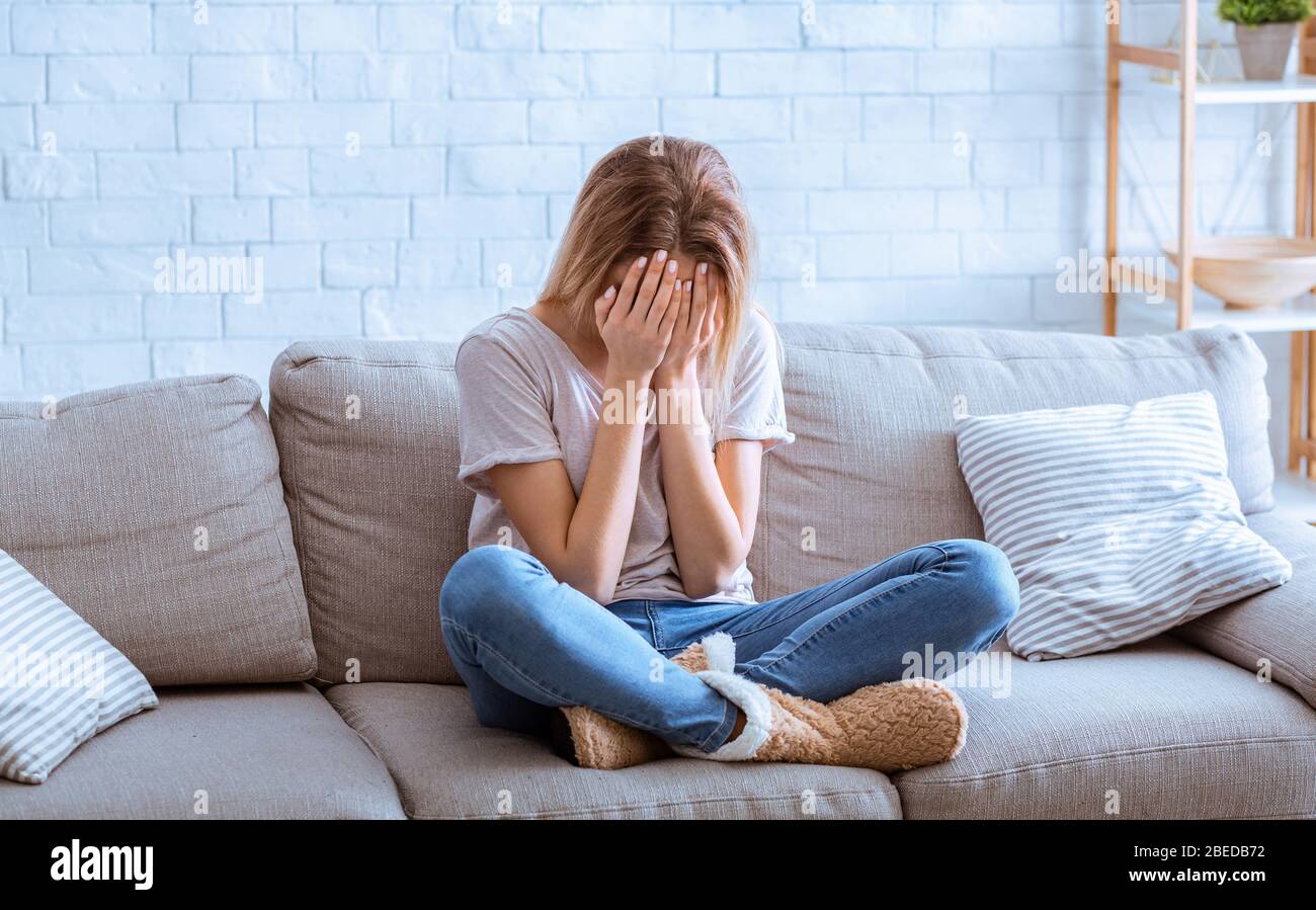Girl in despair covered her face with hands Stock Photo - Alamy