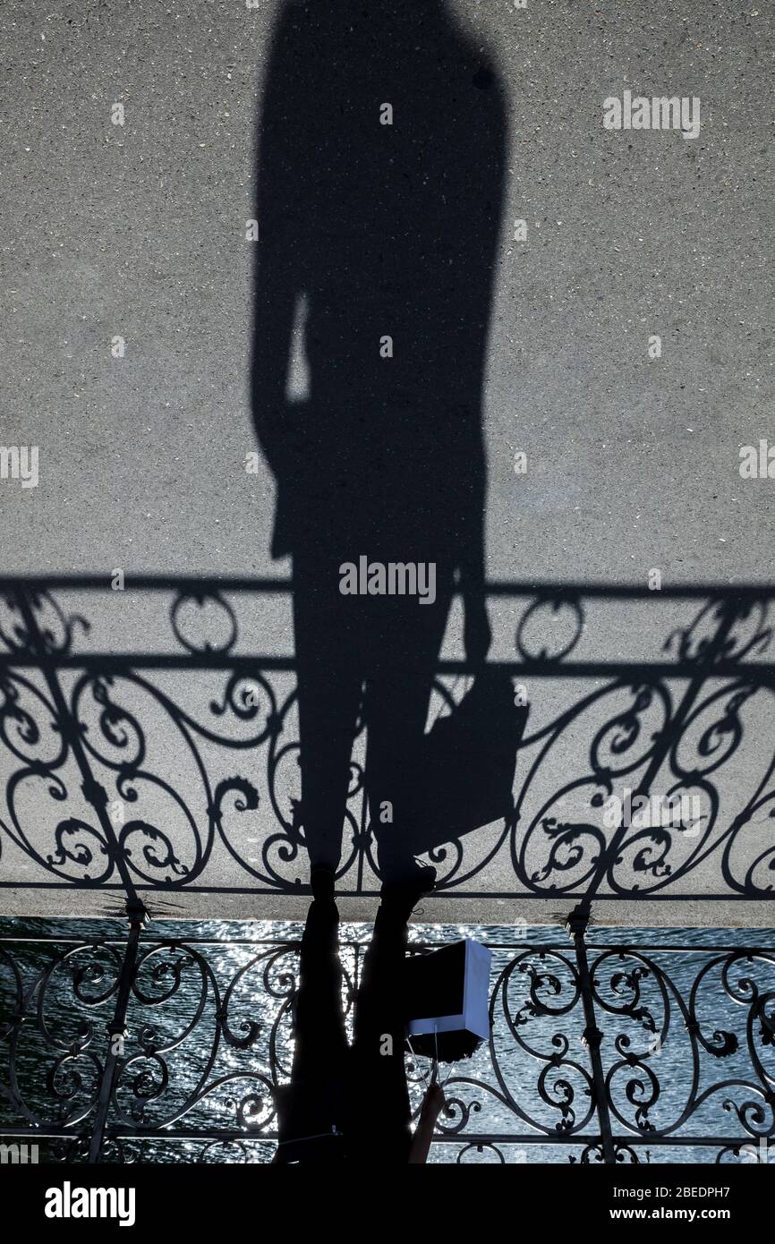Shadow of a person and Railing Holding Shopping Bag Stock Photo - Alamy