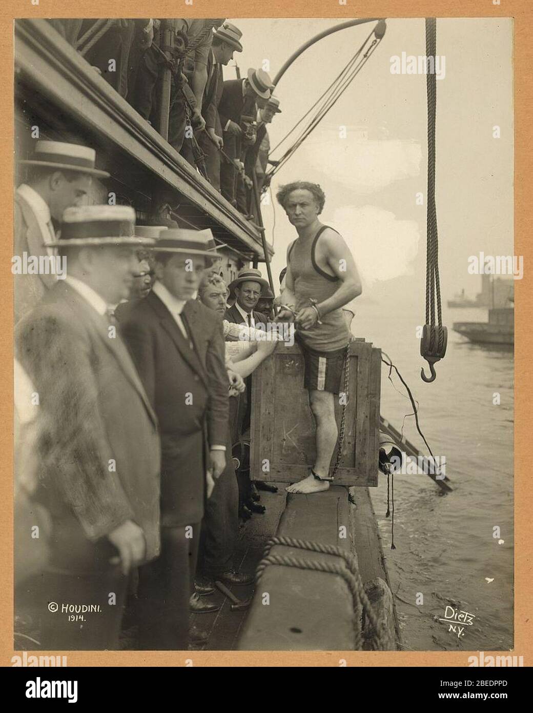 Harry Houdini stepping into a crate that will be lowered into New York ...