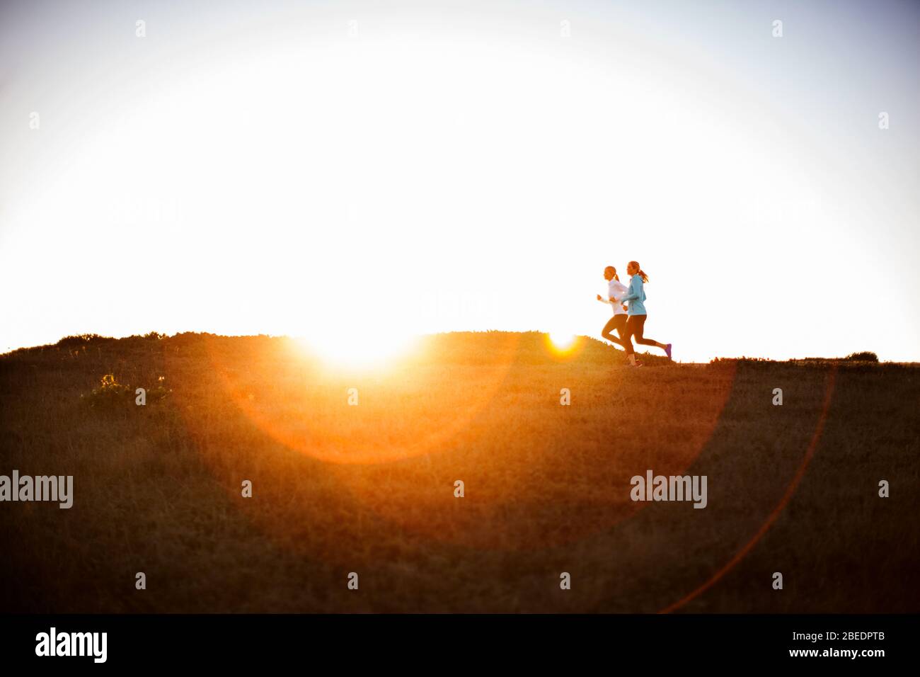 Two people exercising sunset hi-res stock photography and images - Alamy