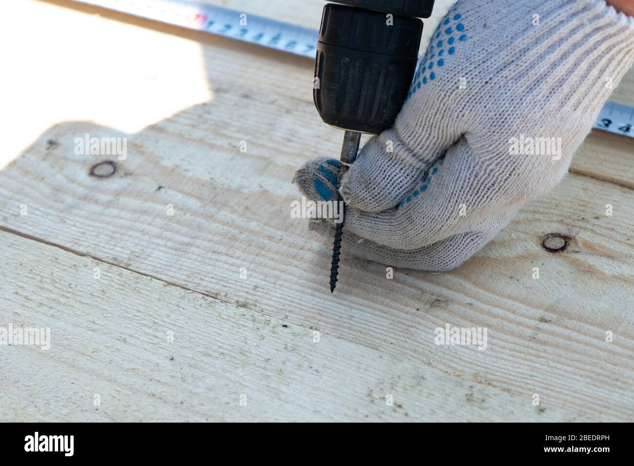 Screwing screw into wooden plank hi-res stock photography and images ...
