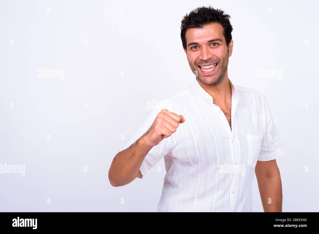 Portrait of happy handsome Turkish man with fist raised Stock Photo - Alamy