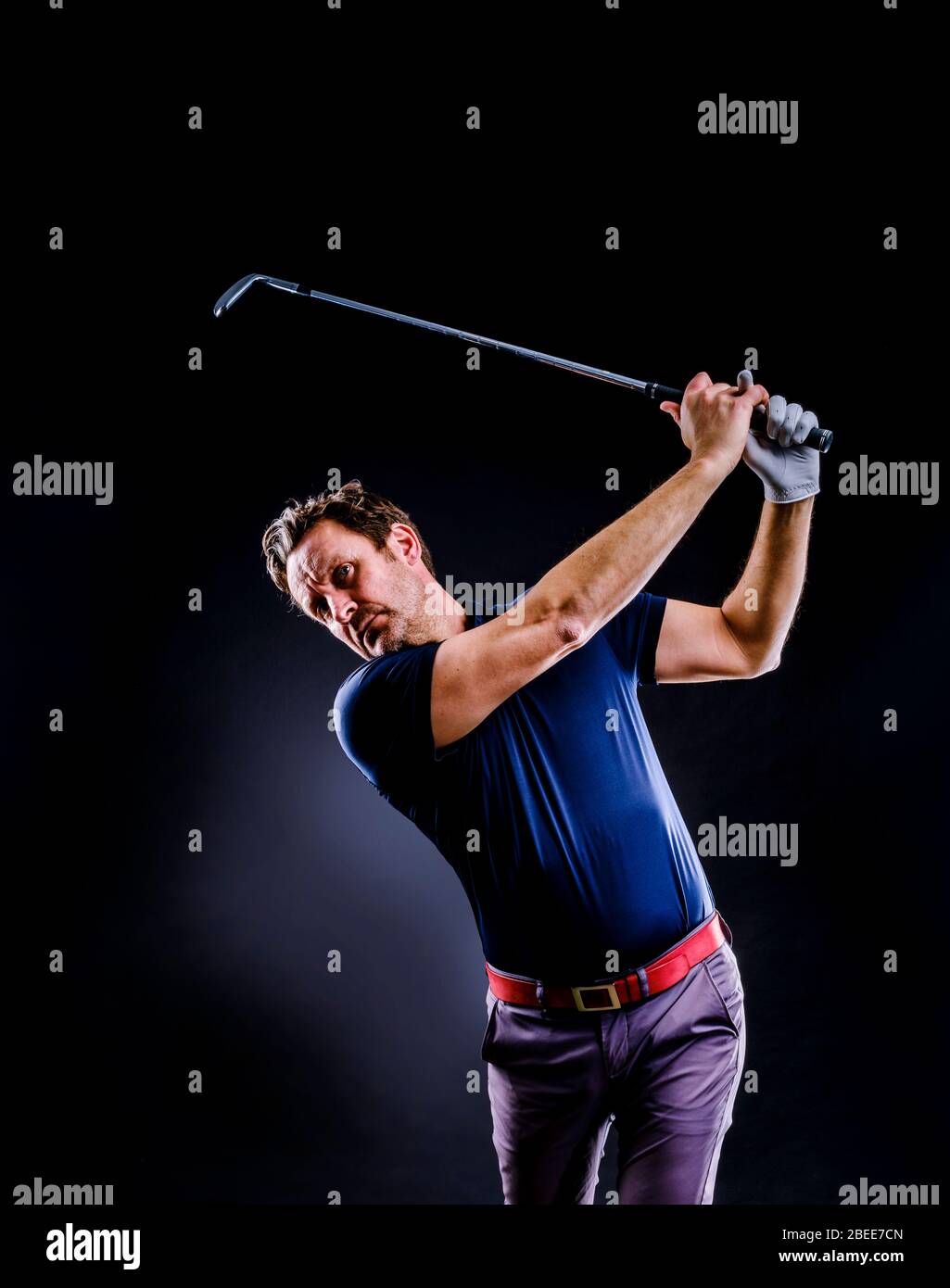 Close-up of a golf player intent on perfecting the swing isolated on ...
