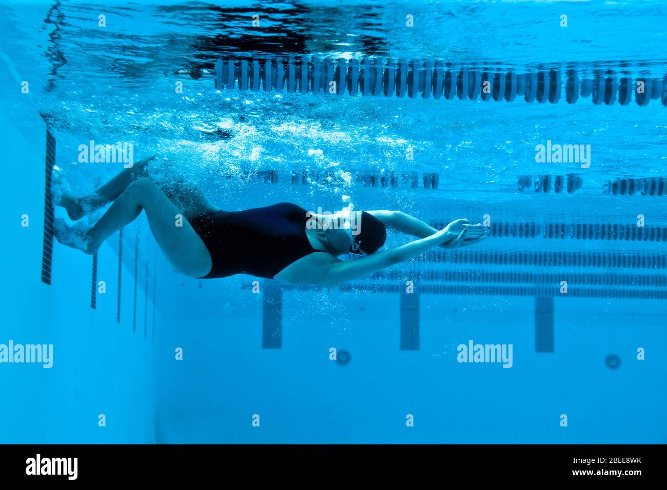 Female swimmer pushing off from the swimming pool wall Stock Photo - Alamy