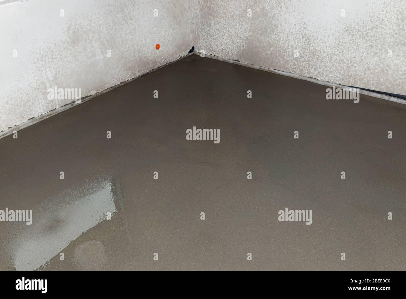 Watering a newly poured floor screed at home to prevent it from ...