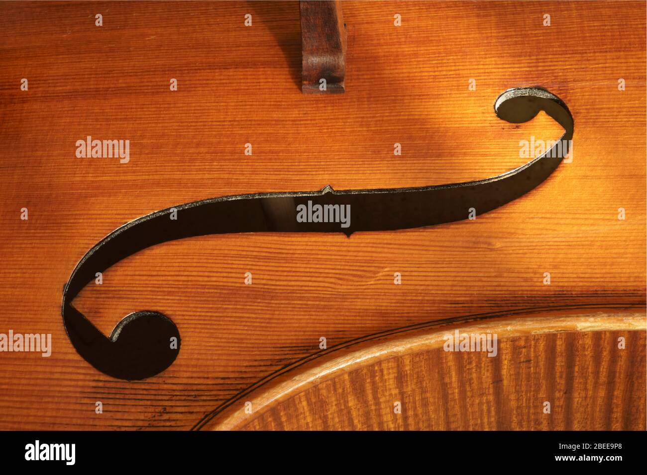 Detail of the acoustic panel of a cello with a textured wooden ...