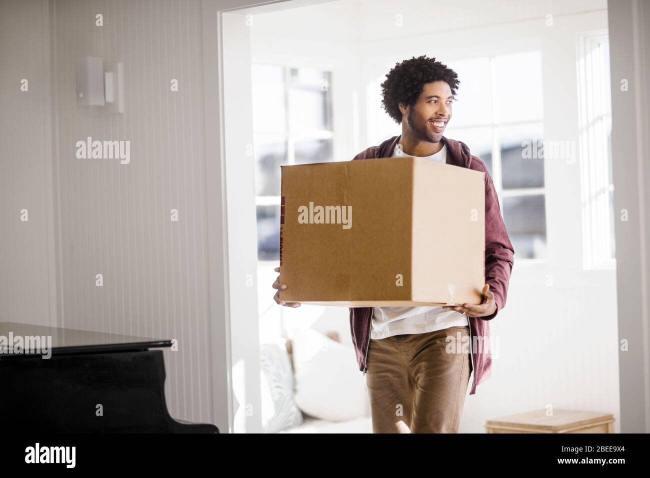 Happy young man moving into a new home Stock Photo - Alamy