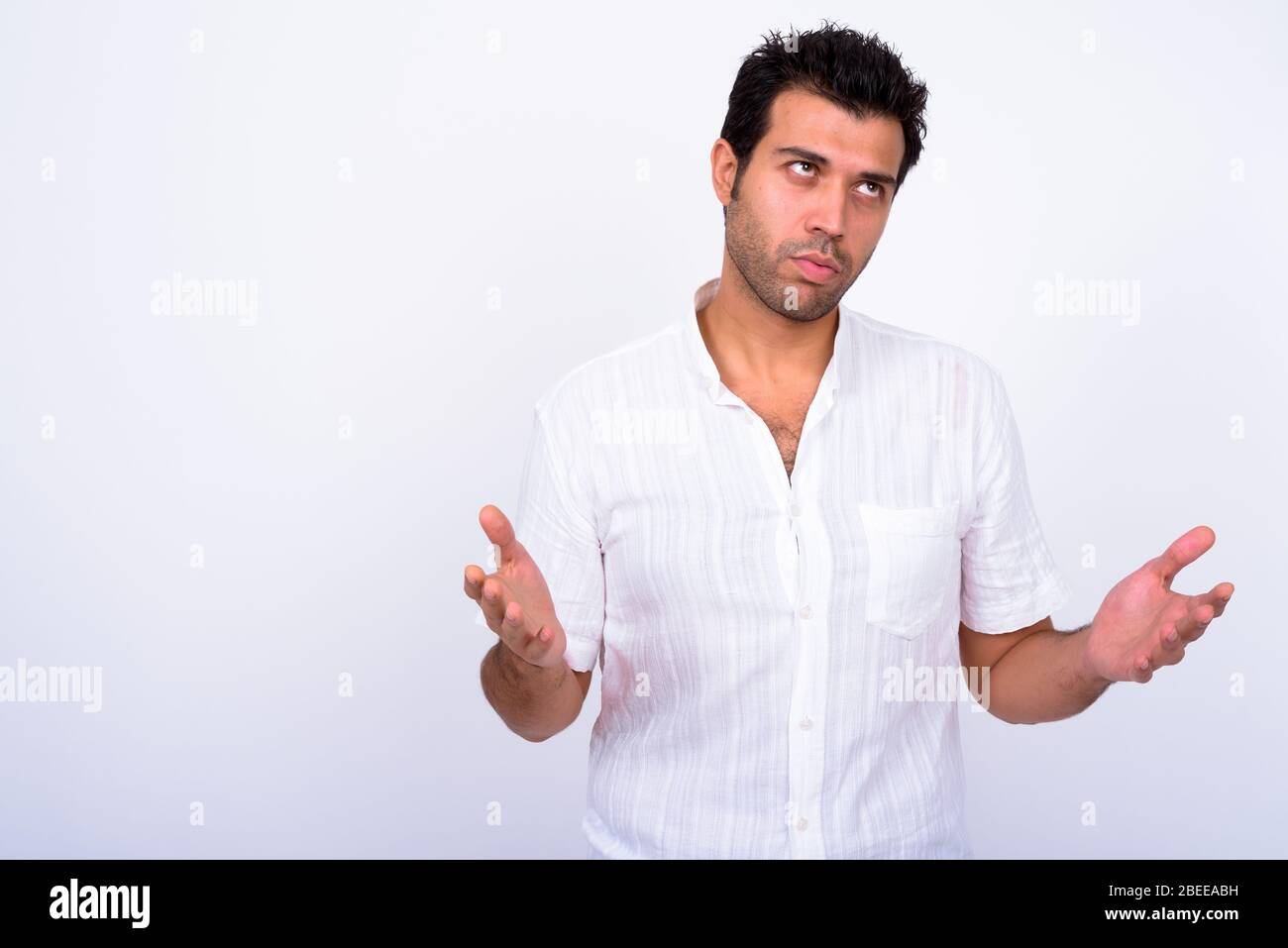 Portrait of stressed Turkish man shrugging shoulders Stock Photo - Alamy