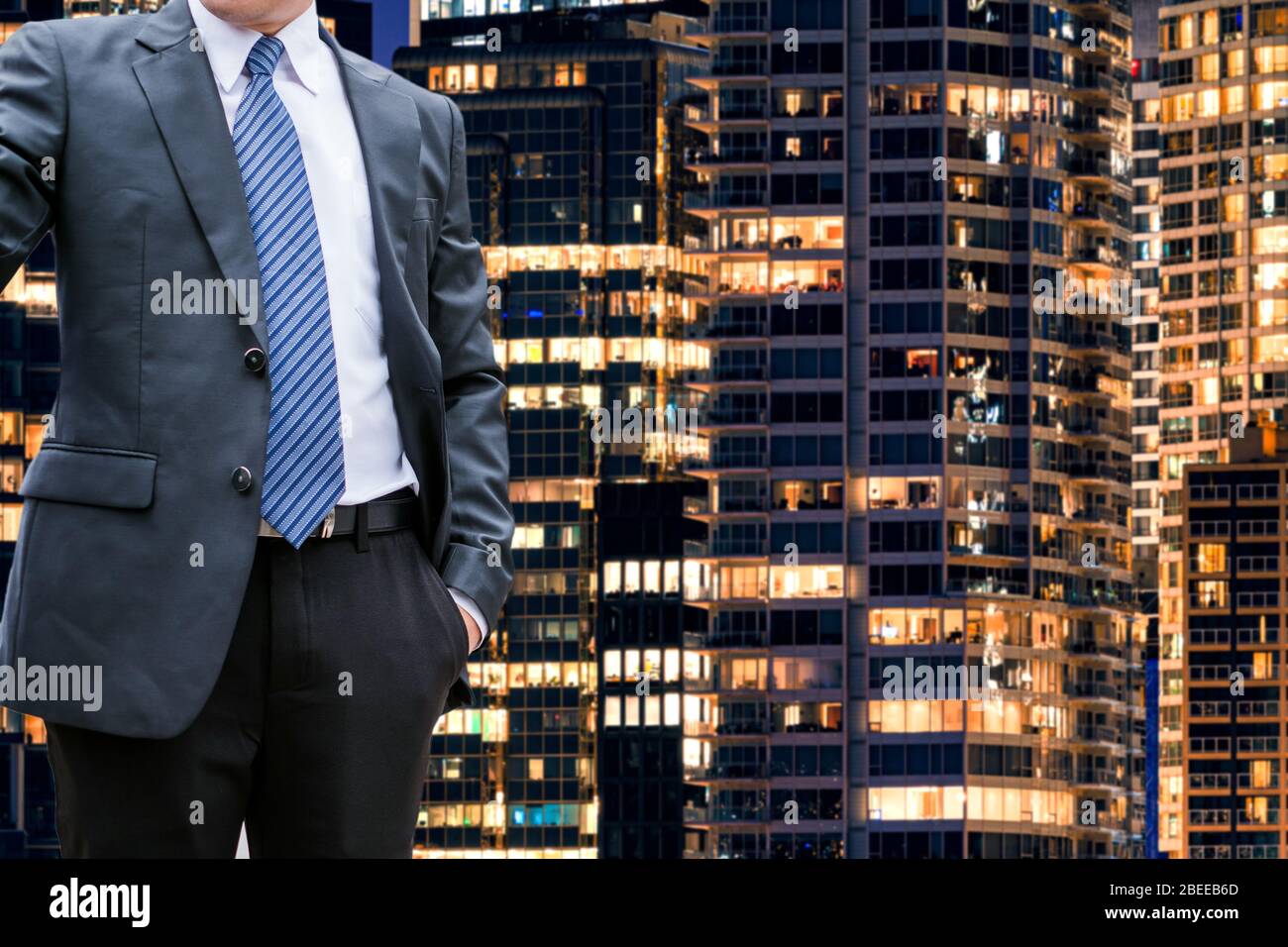 Smart businessman standing on office building illumination background ...