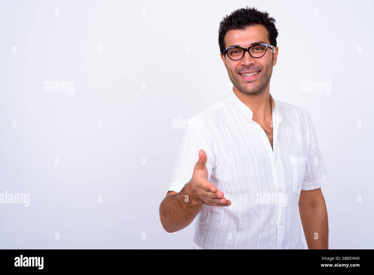Portrait of happy handsome Turkish man giving handshake Stock Photo - Alamy