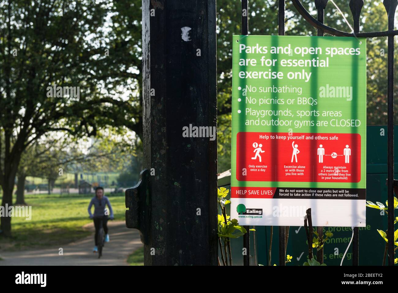 Park entrance with Ealing Council sign publicising UK government ...