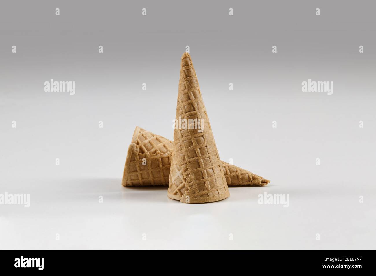 Two empty, small wafer cones for ice cream isolated on white. Concept ...