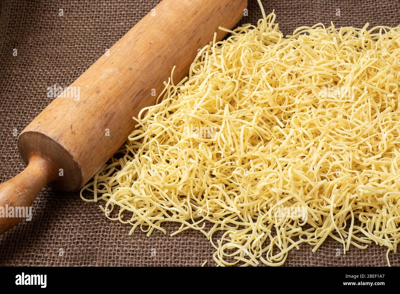 Fresh homemade noodles and wooden kitchen rolling pin Stock Photo - Alamy