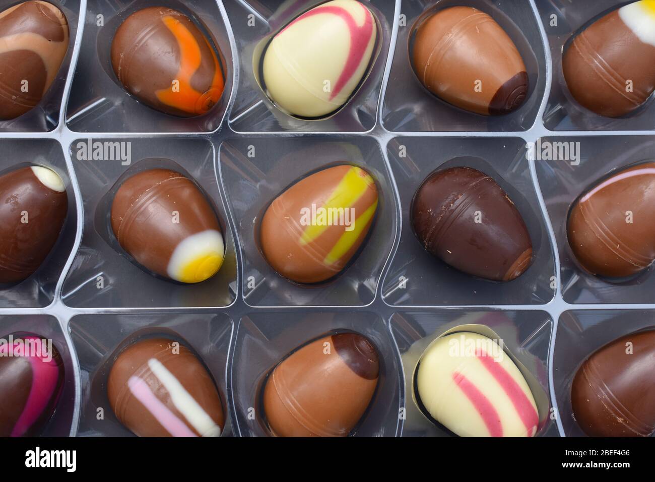 Selection of chocolates Smooth pralines with pistachios macadamia nuts ...