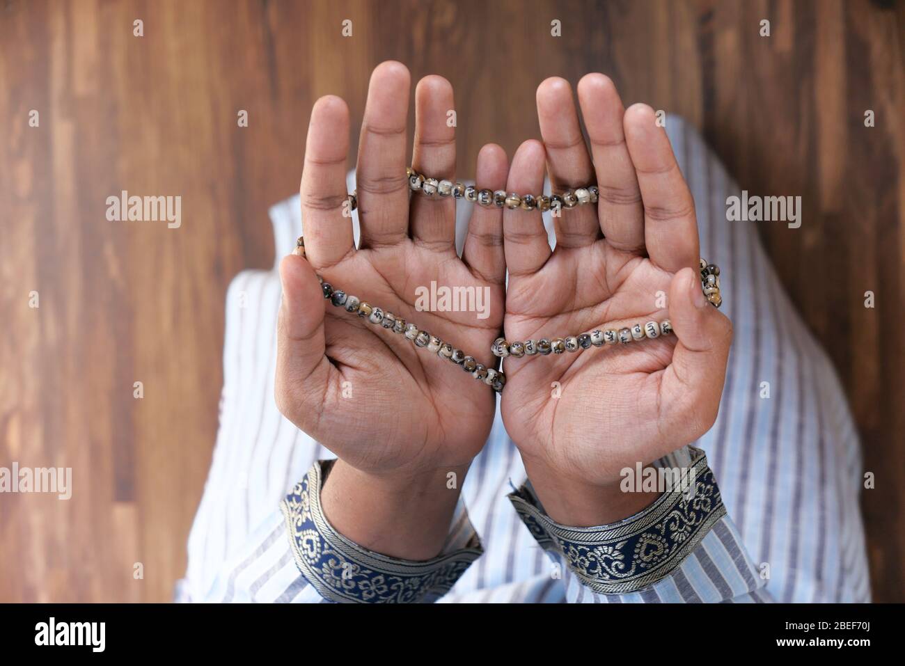 Religious muslim young man praying , high angle view Stock Photo - Alamy