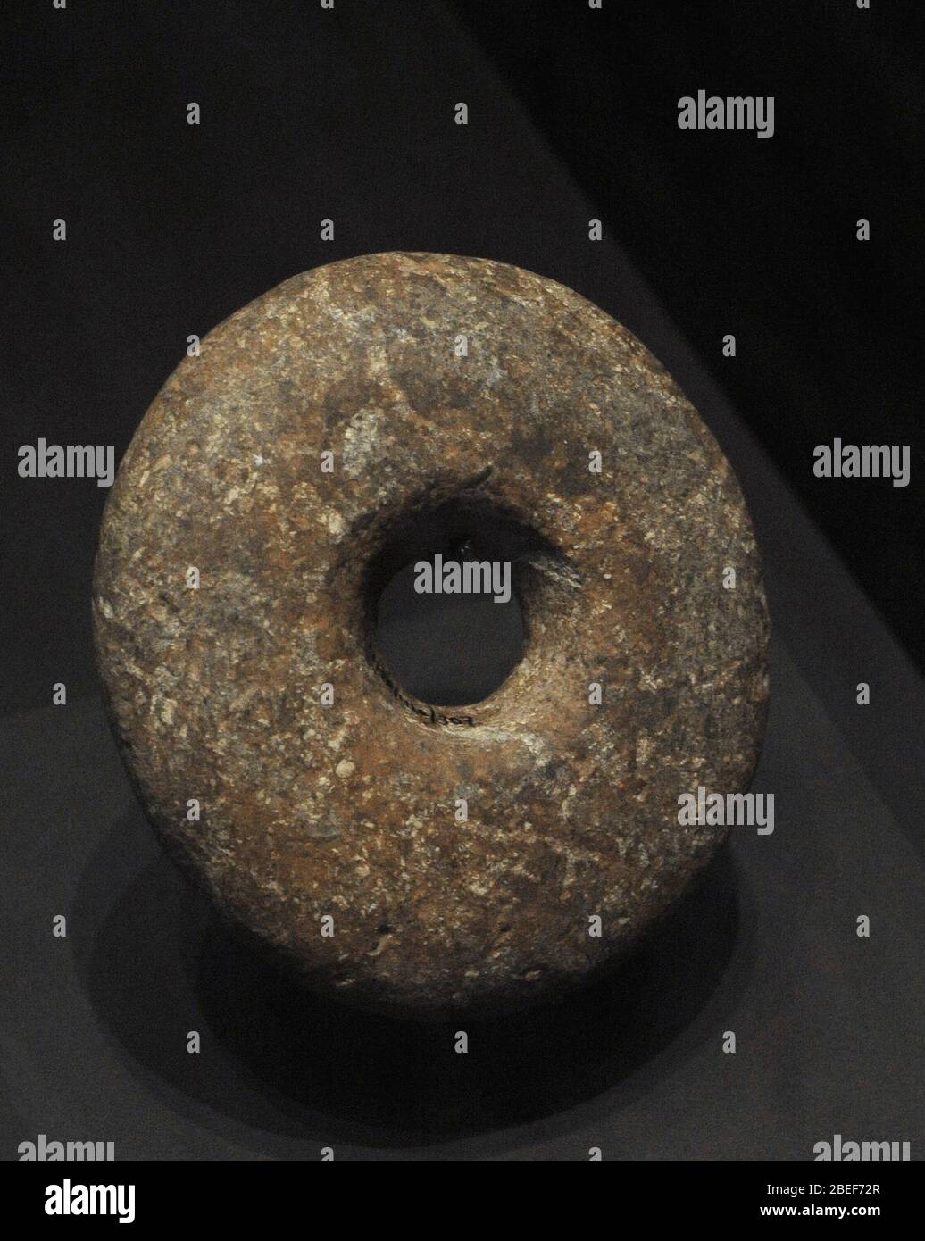 Stone weight from a digging stick Stock Photo - Alamy