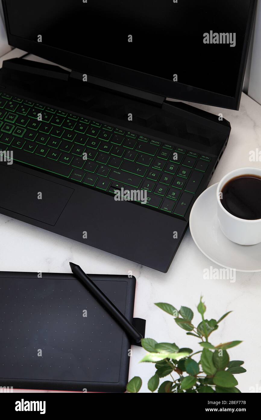 Working space at home. Computer, morning coffee and tablet for remote ...