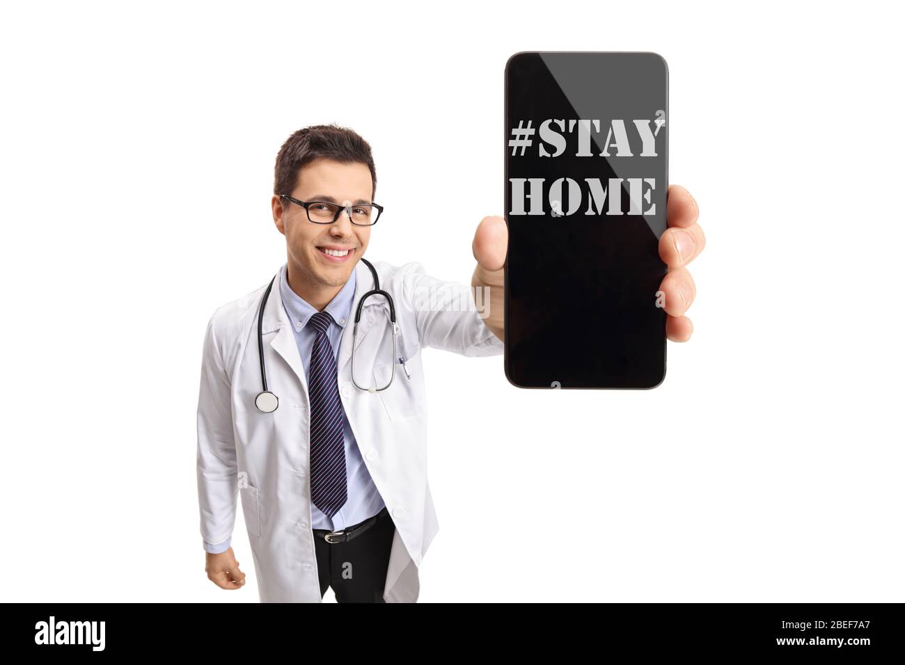 Male doctor showing a phone displaying message stay home isolated on ...