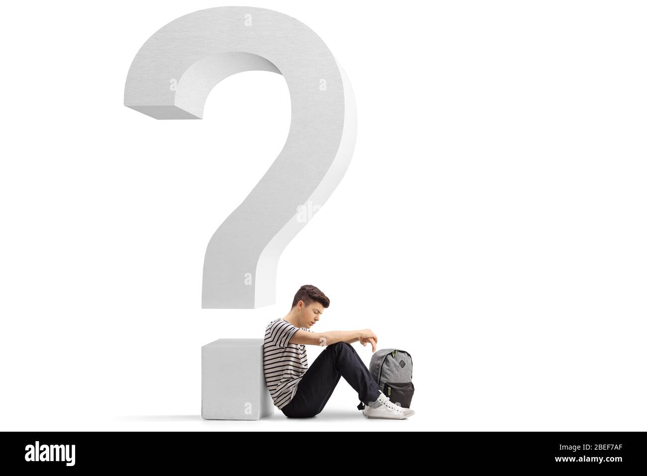 Sad male student sitting on the floor and leaning against a question ...