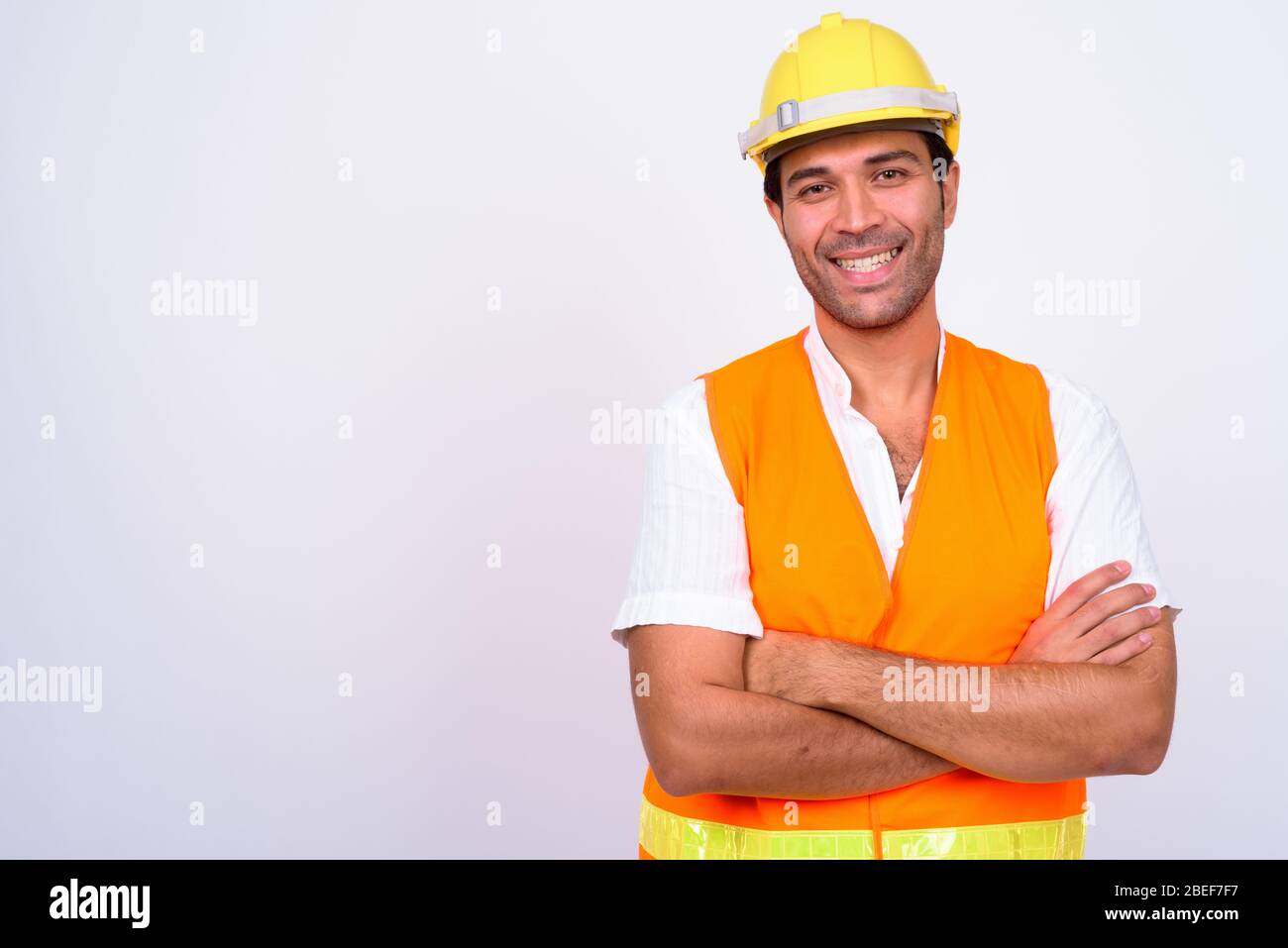 Happy handsome Turkish man construction worker smiling with arms ...