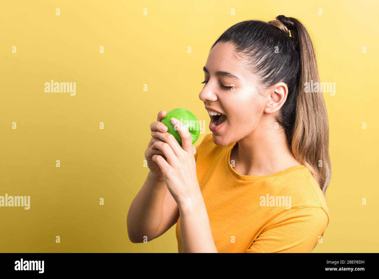 healthy lifestyle. starving girl on diet about to bite an apple with ...