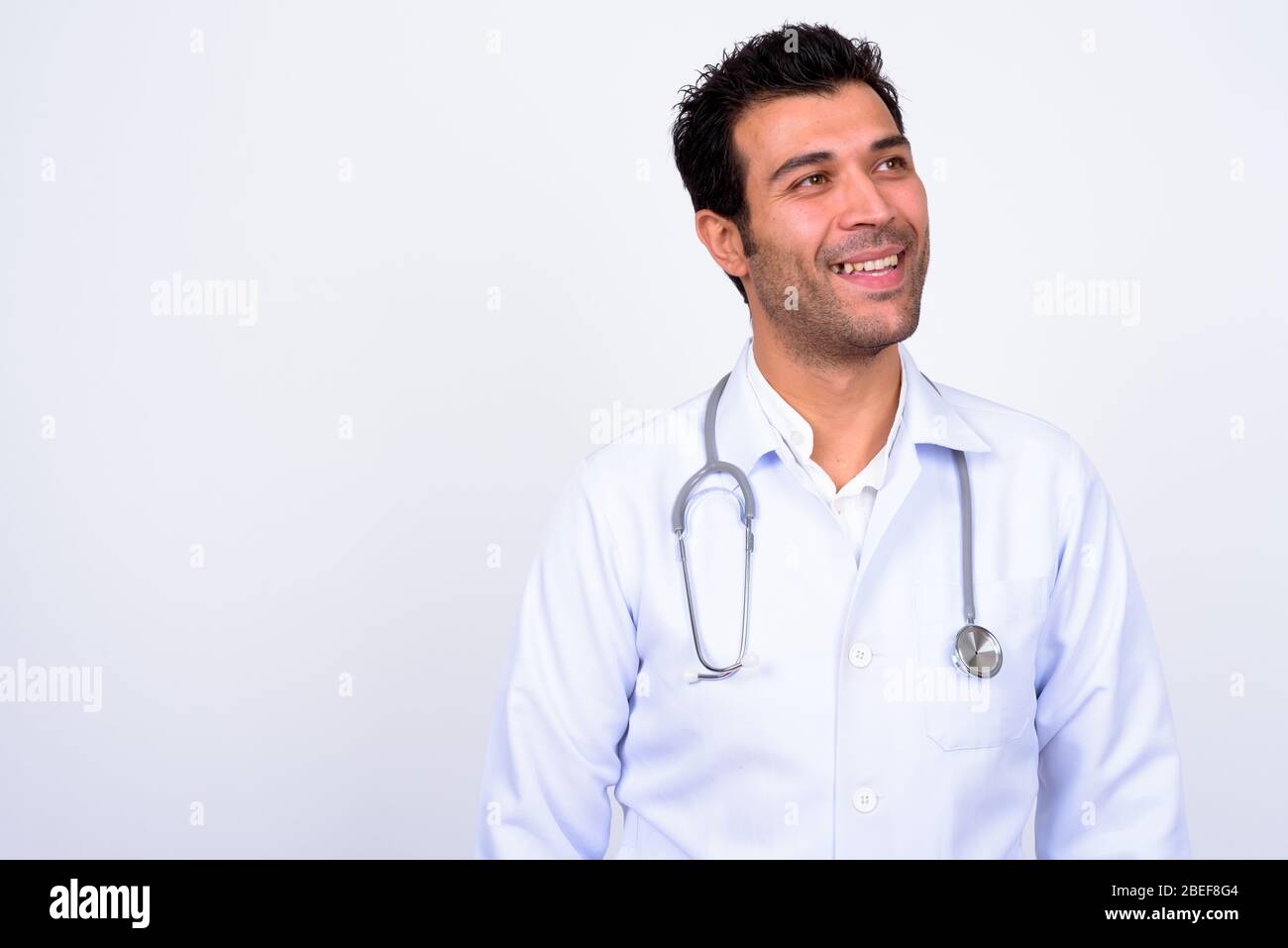 Handsome Turkish man doctor against white background Stock Photo - Alamy