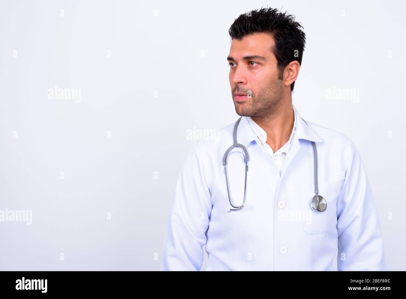 Handsome Turkish man doctor against white background Stock Photo - Alamy