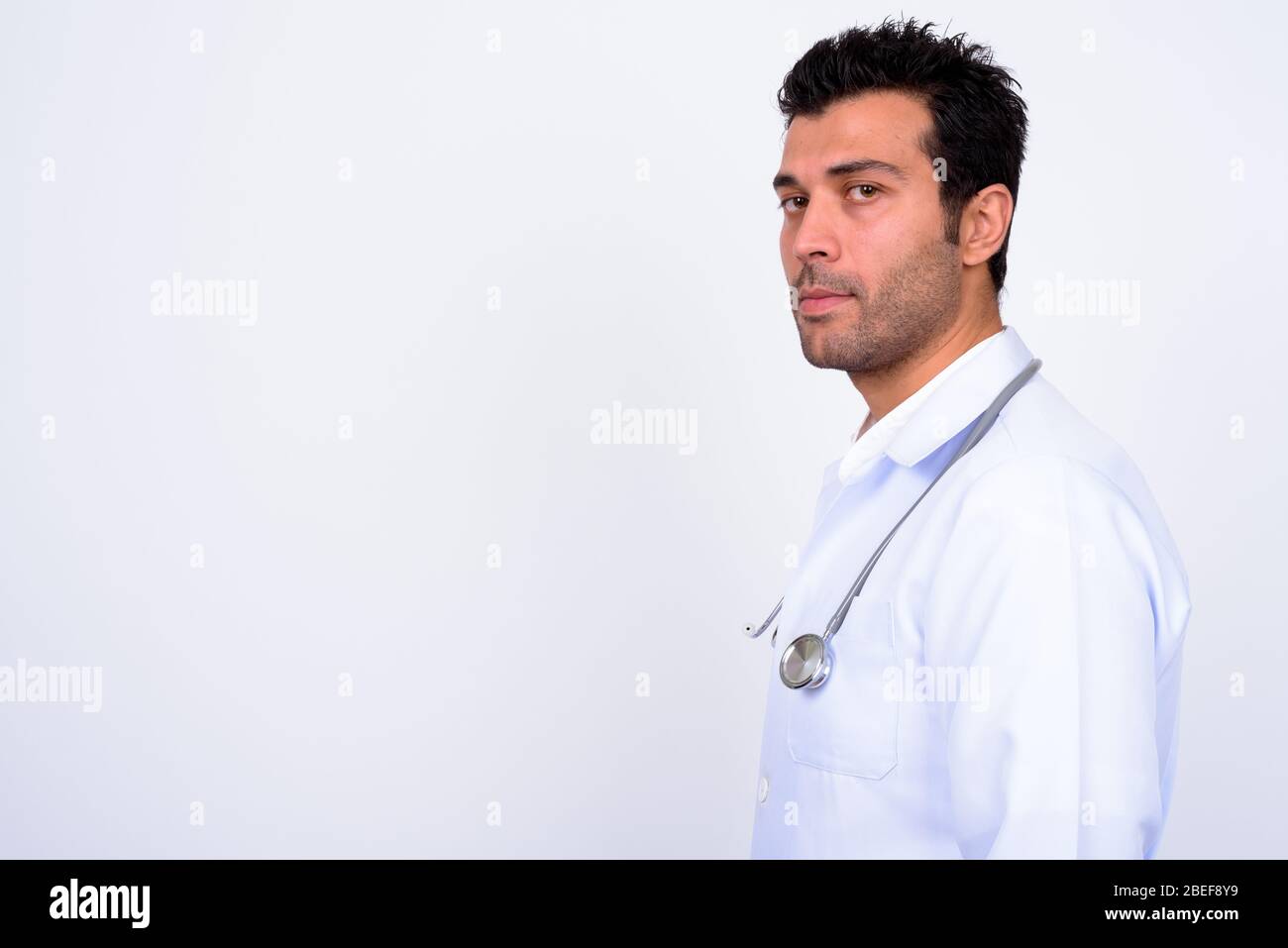 Handsome Turkish man doctor against white background Stock Photo - Alamy