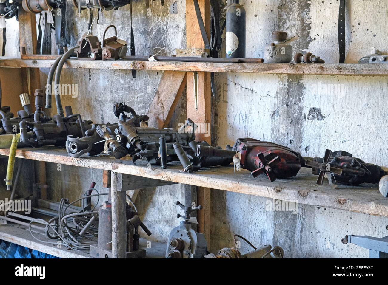 Rusty old tools and equipment parts on shelves in the maintenance room ...