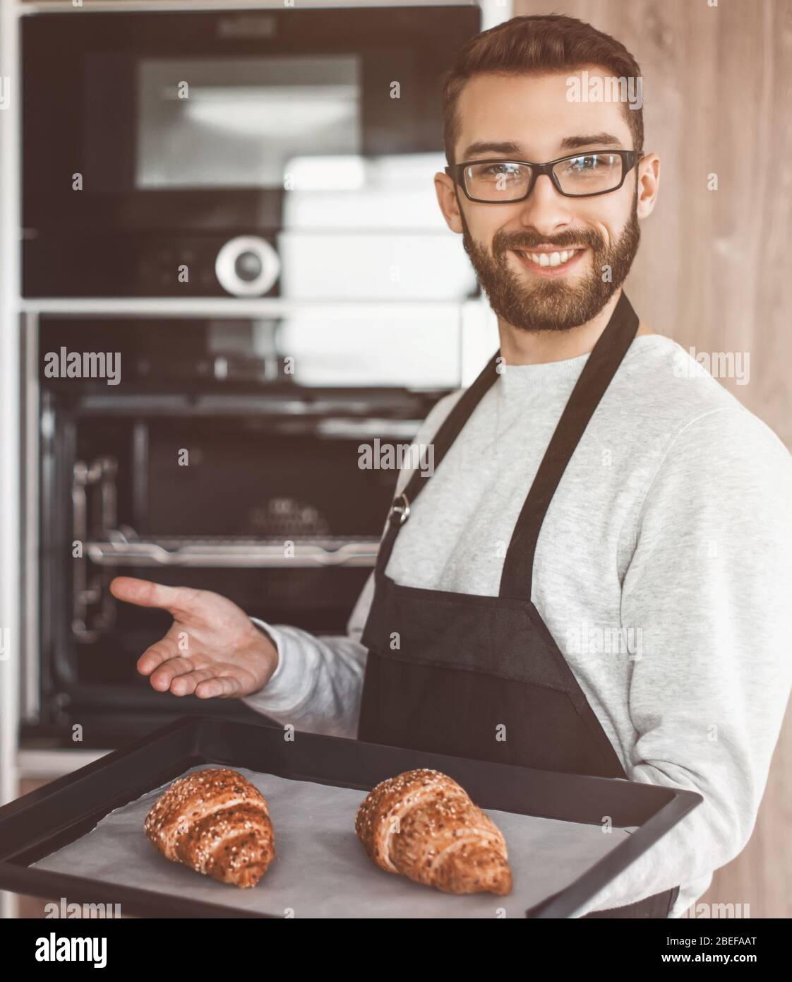 Smiling handsome man holding baking hi-res stock photography and images ...