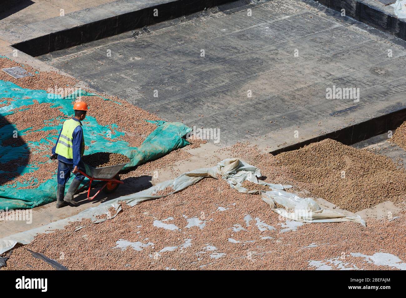 The process of thermal insulation of the roof by workers, by filling ...