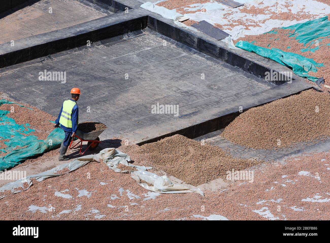 The process of thermal insulation of the roof by workers, by filling ...