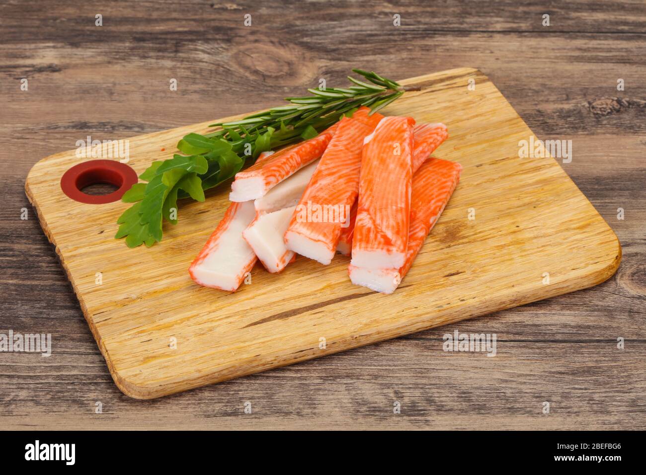 Crab stick surimi over wooden board Stock Photo - Alamy