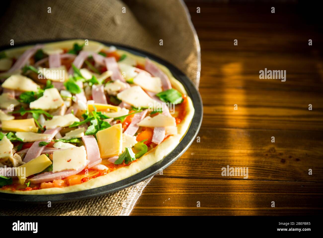 raw pizza with assorted filling in a metal form Stock Photo - Alamy