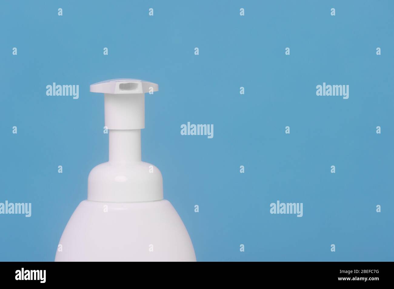 Hand sanitizer bottle or alcohol gel on blue background. Antiseptic ...