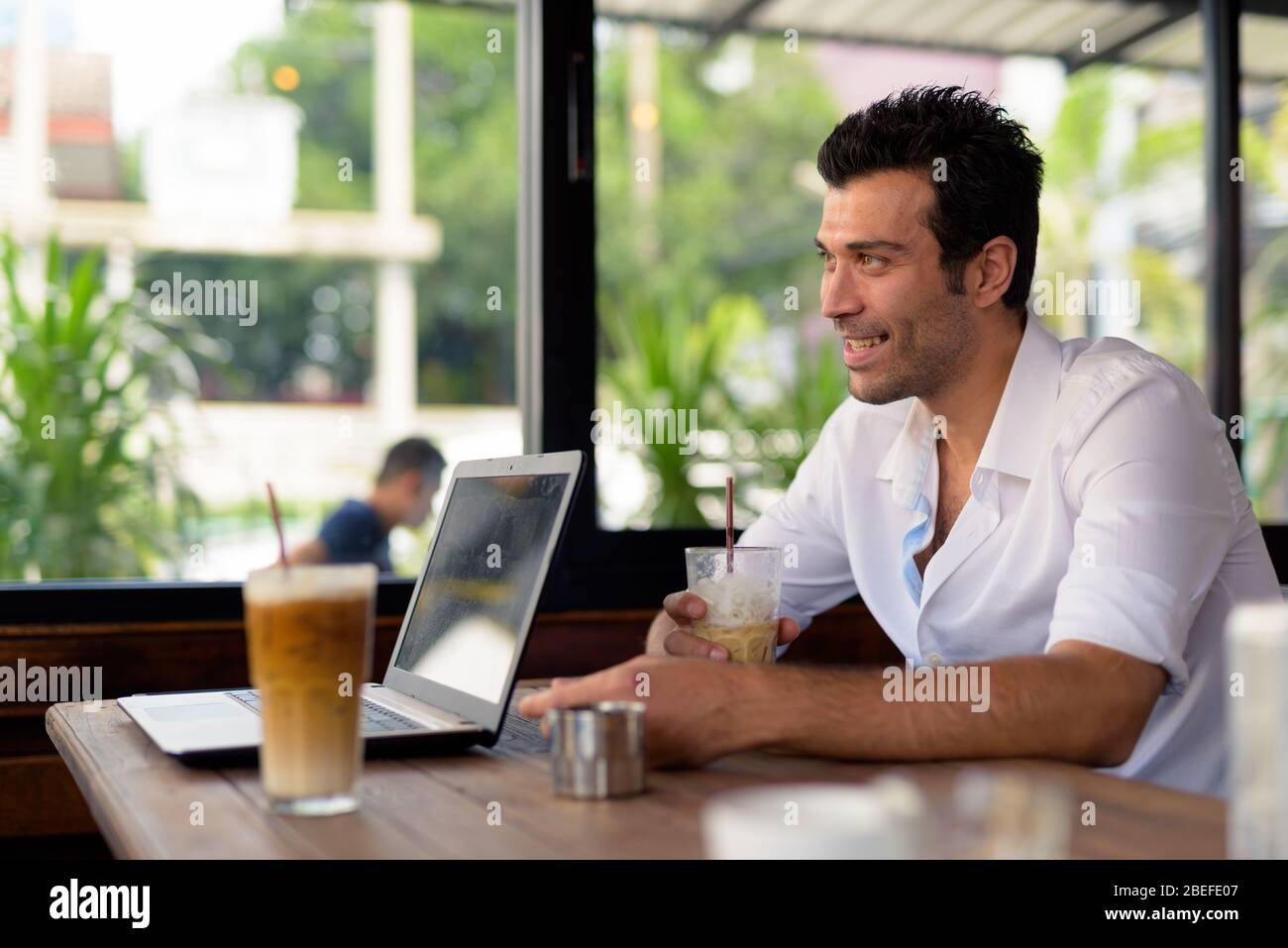 Portrait of happy Turkish man smiling at the coffee shop Stock Photo ...