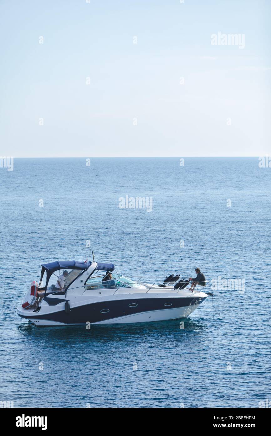 small motor speed boat in sea water with men Stock Photo - Alamy
