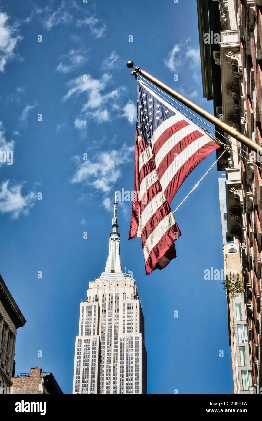 The Iconic Empire State Building Is Viewed With An American Flag On