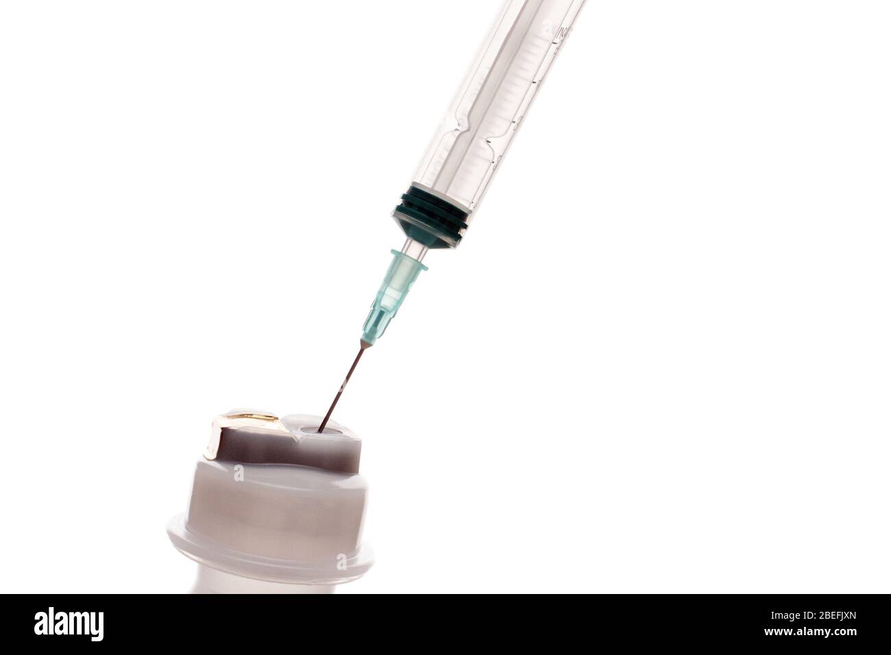 Empty syringe for injection with a neck of a plastic bottle on a white ...