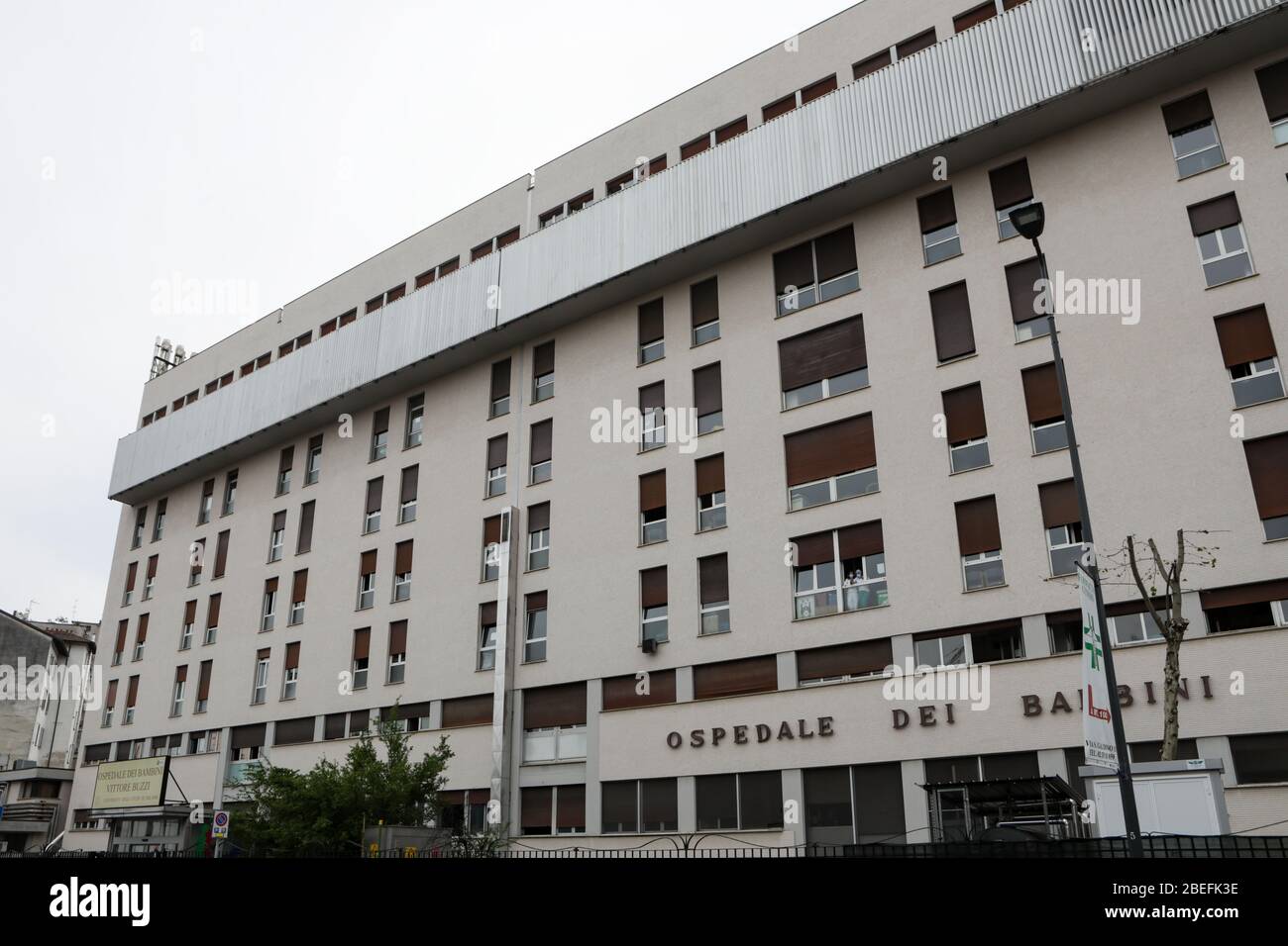 Two nurses look out the window of the Buzzi hospital during a moment of ...