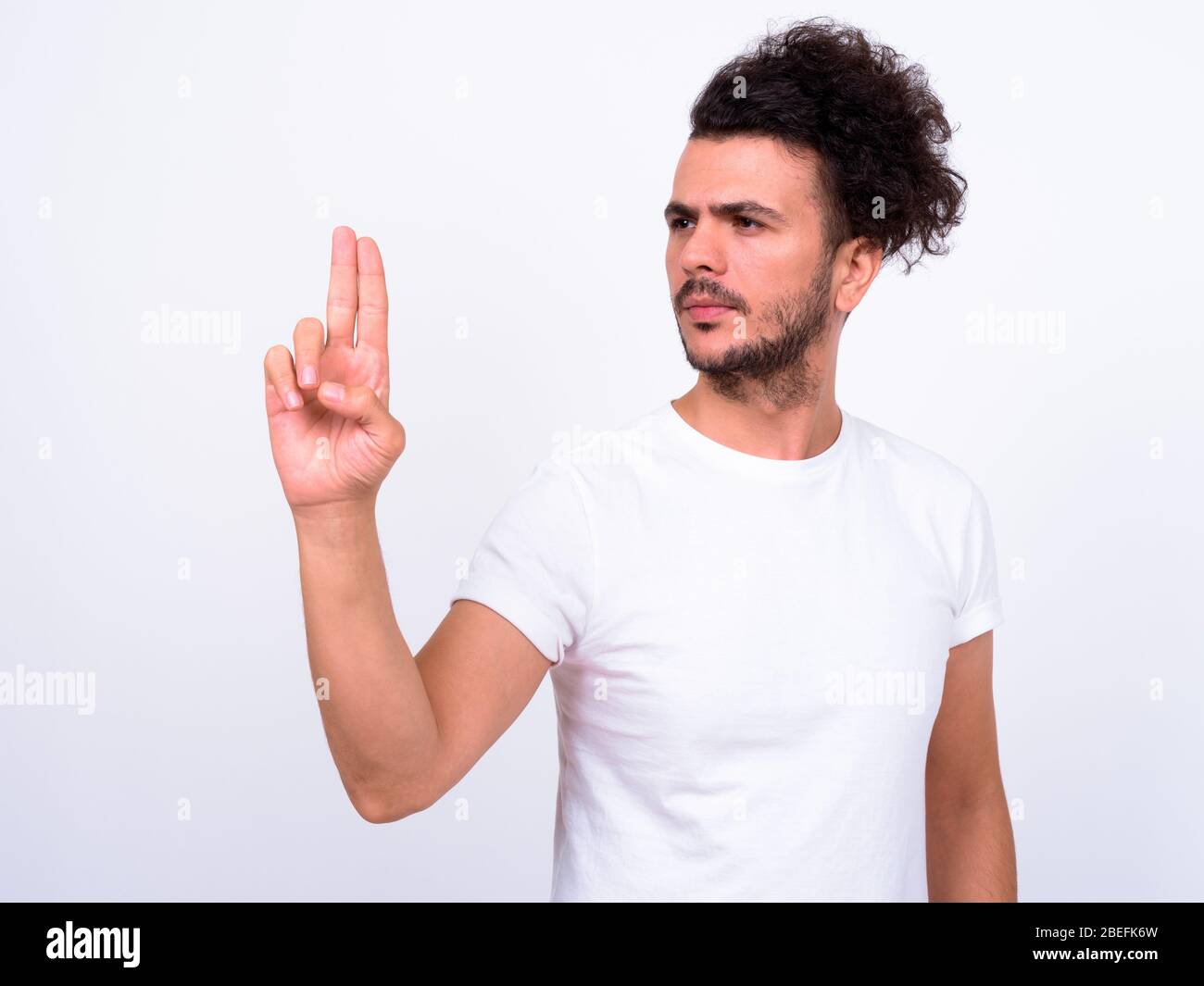 Portrait of handsome bearded Turkish man touching something Stock Photo ...