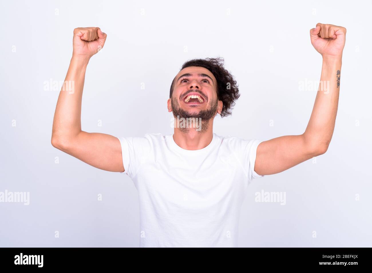 Portrait of happy bearded Turkish man with fists raised Stock Photo - Alamy