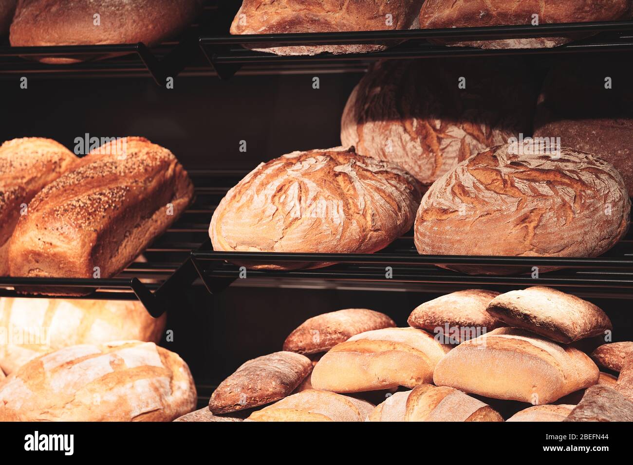 Fresh breads on the shelf in the bakery Stock Photo - Alamy