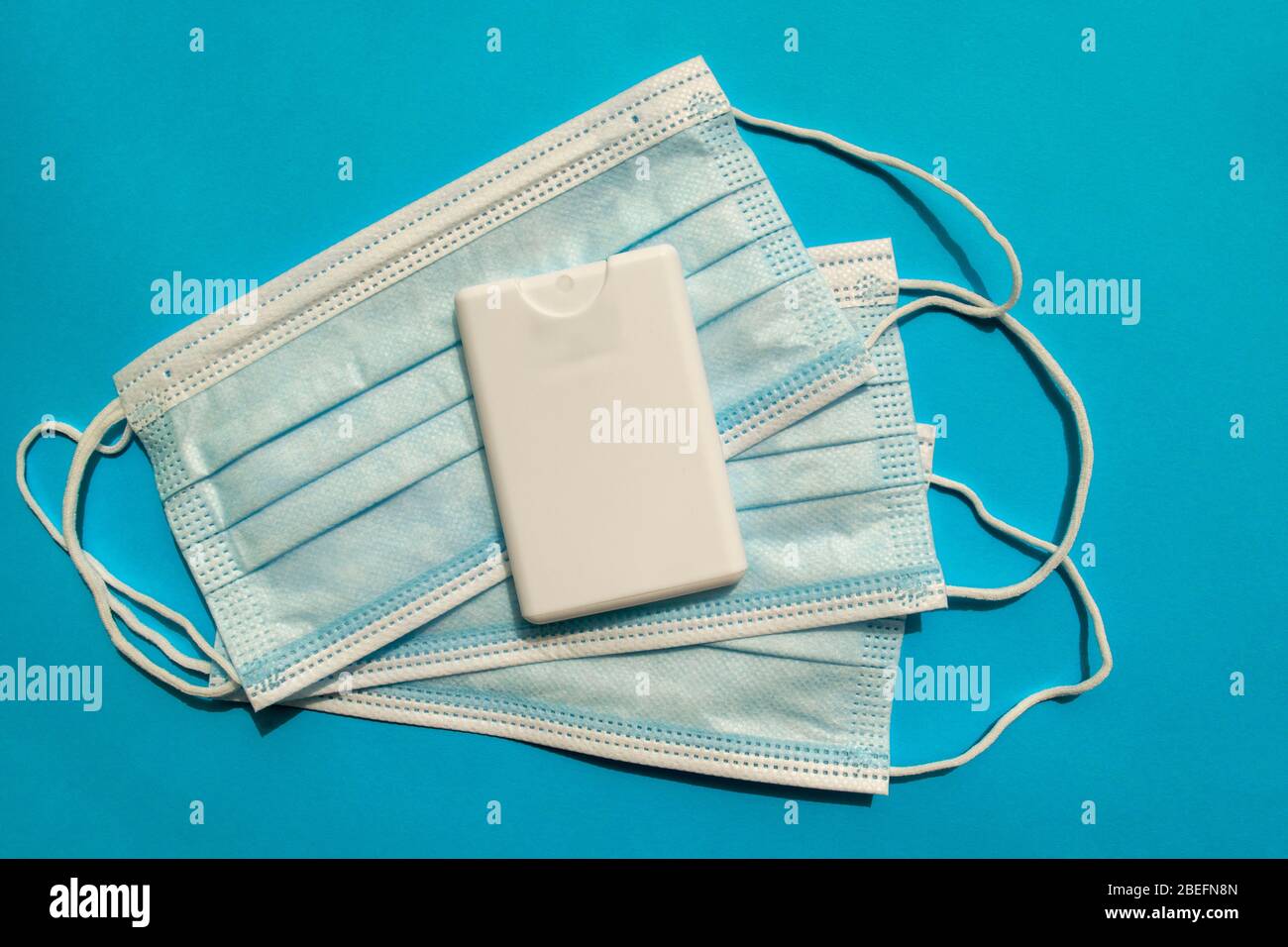 Surgical disposable face masks and hand sanitizer spray in a small ...