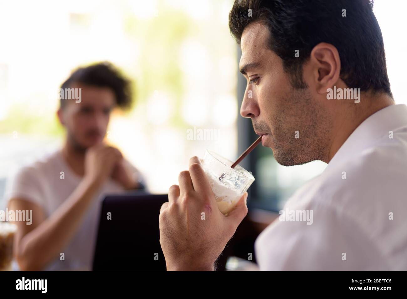 Two handsome Turkish men hanging out and relaxing at the coffee shop ...